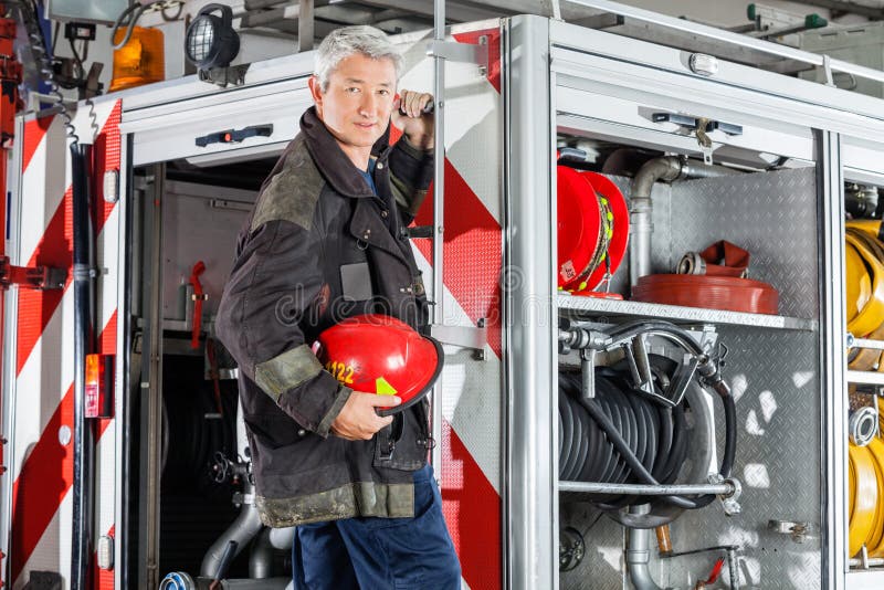 Confident Fireman Standing on Fire Engine Stock Image - Image of ...