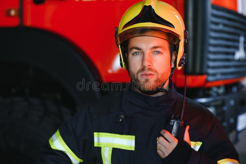 Confident Fireman Wearing Protective Uniform Standing Next To a Fire ...