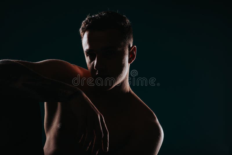 Confident Fit Man Showing Muscles in Powerful Studio Pose Stock Photo ...