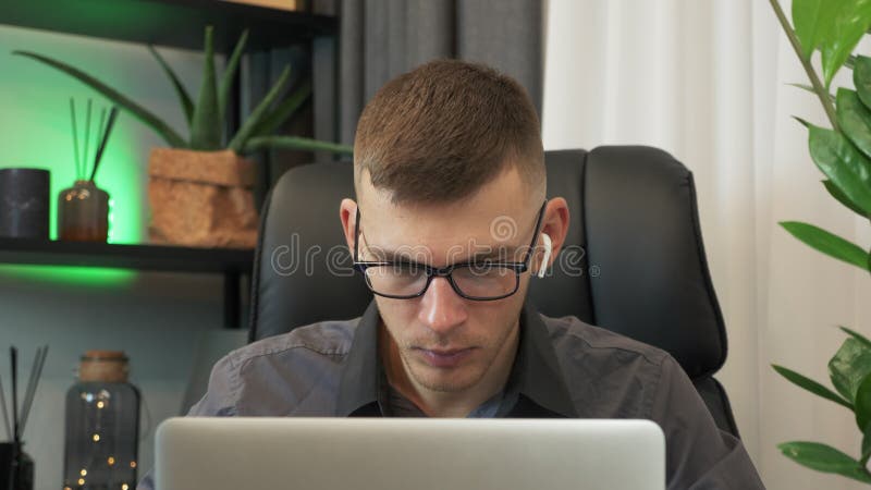 Confident Focused Young Man is Working on Laptop Computer at His Modern ...