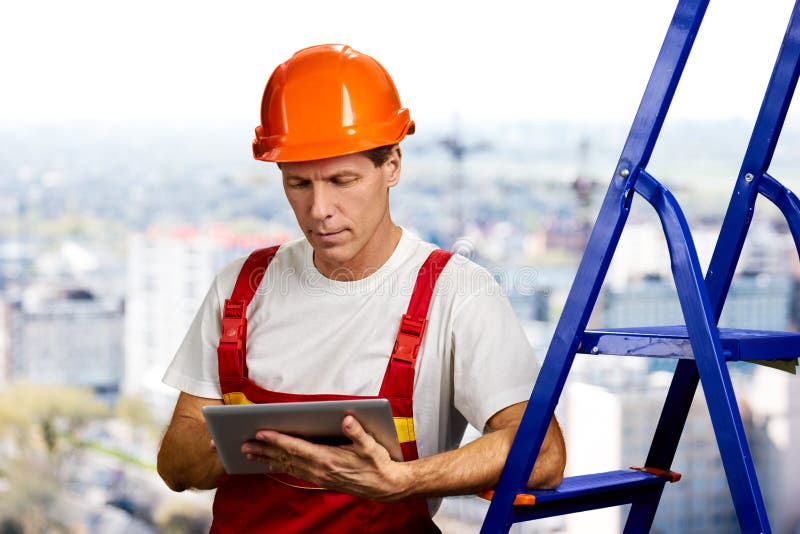 Confident Foreman Working on Digital Tablet. Stock Photo - Image of ...