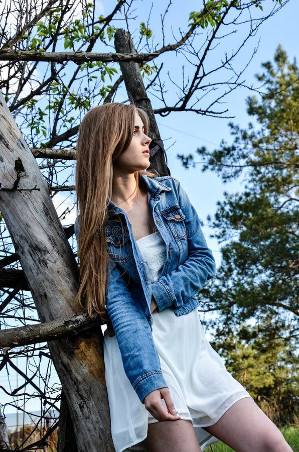 The Confident Girl with Brooding Look Leaning on the Tree Stock Image ...