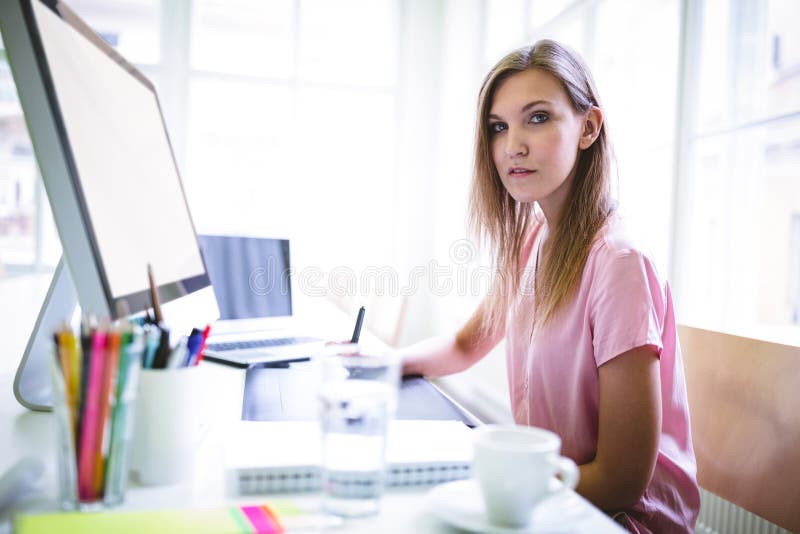 Confident Graphic Designer Sitting at Desk Stock Photo - Image of ...