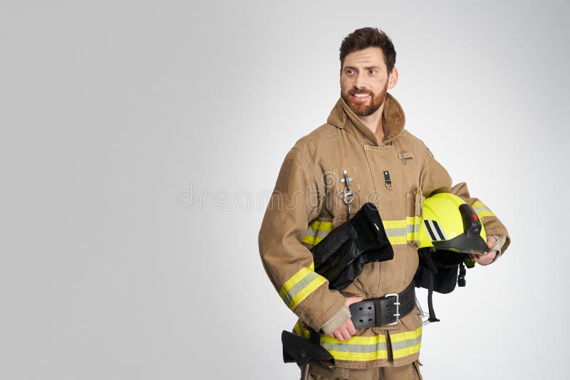 Confident Guy in Fireman& X27;s Uniform Smiling and Posing in Studio ...