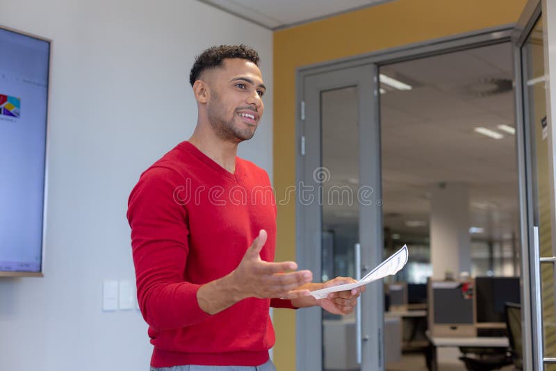 Confident Hispanic Male Professional Holding Document while Explaining ...