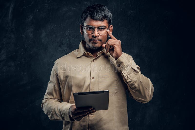Confident Indian Man in Eyewear and Shirt Holding a Tablet Computer and ...
