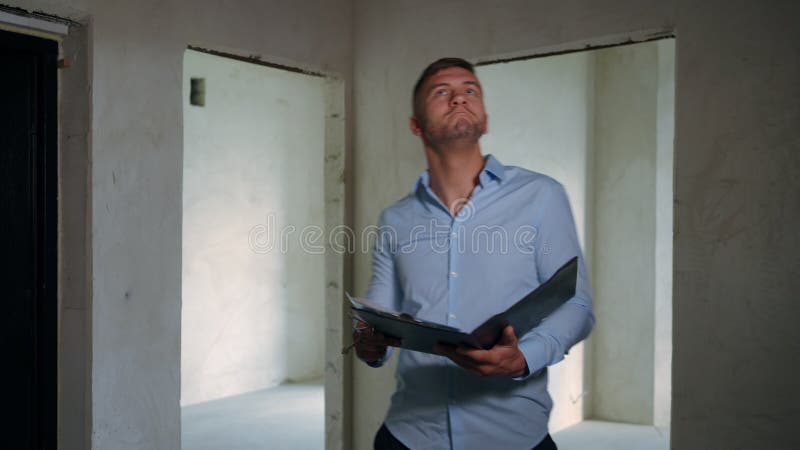 Confident Intelligent Inspector Standing with Paperwork in Building ...