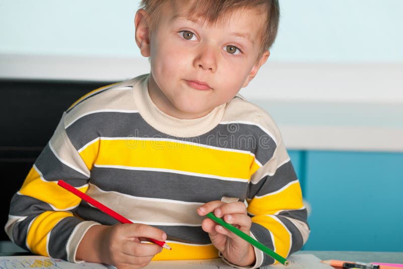 Confident Little Boy is Sitting at the Desk Stock Photo - Image of ...