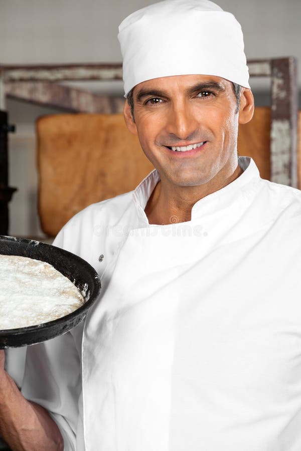 Confident Male Baker Holding Dough Tray at Bakery Stock Photo - Image ...