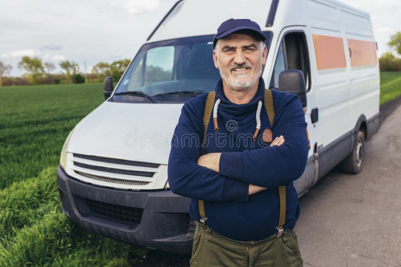 Confident Male Driver Standing in Front on His Van and Looking at ...