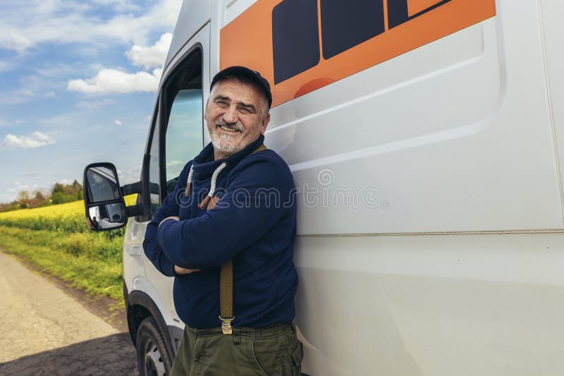 Confident Male Driver Standing in Front on His Van and Looking at ...