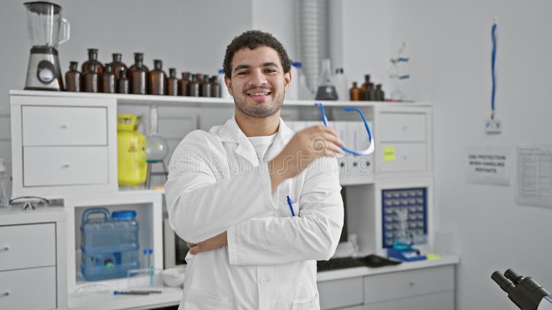 Confident Male Scientist in Lab Coat Adjusting Safety Glasses in Modern ...