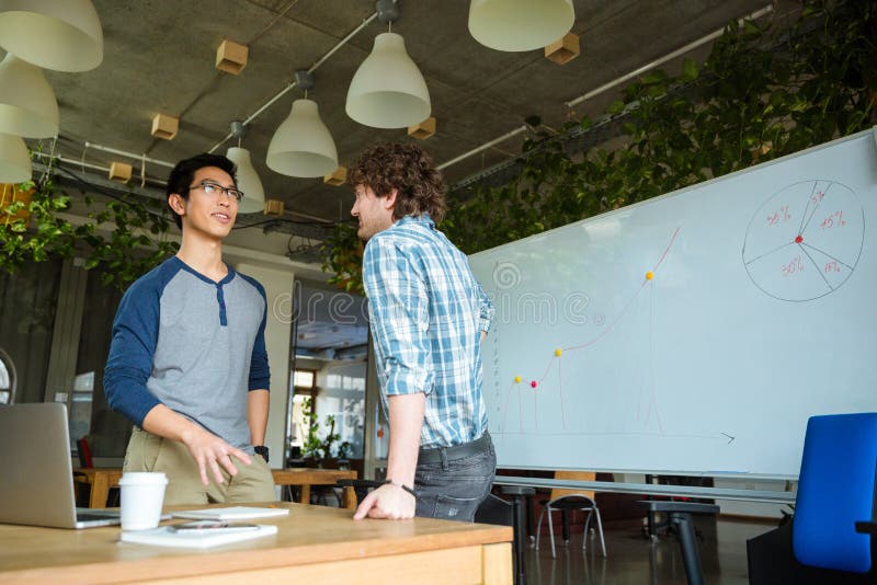 Confident Male Students Standing and Talking in Classroom Stock Image ...