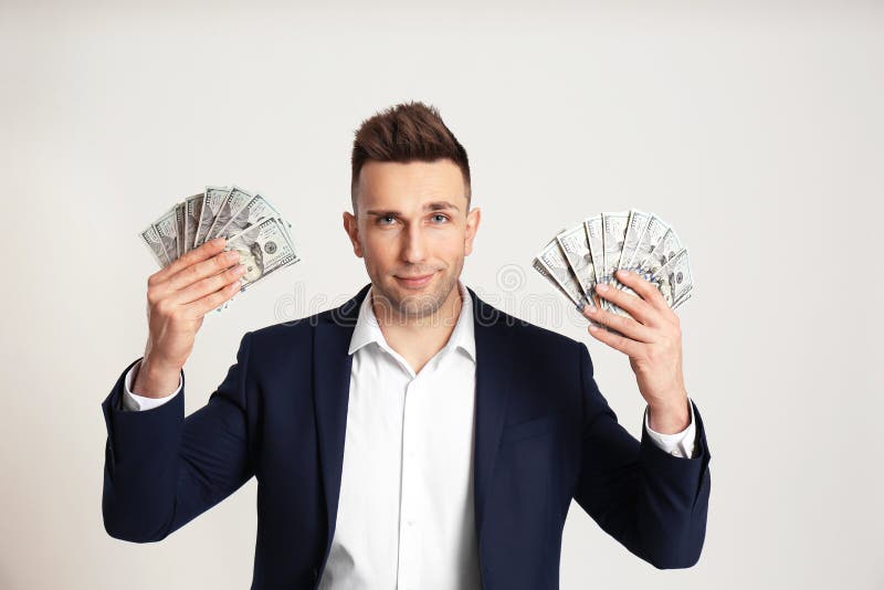 Confident Man with Cash Money on Light Grey Background Stock Image ...