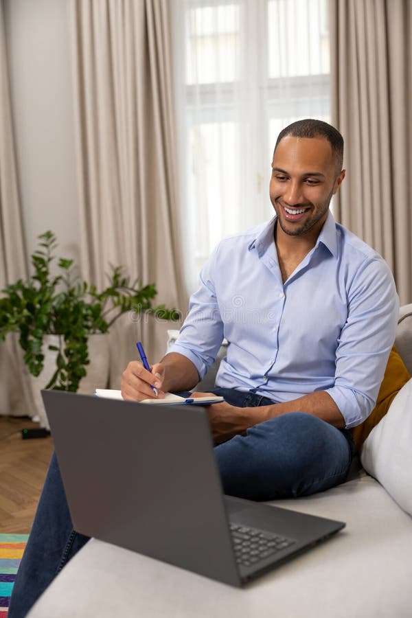 Man Freelancer Working Online on Laptop while Sitting on Couch at Home ...