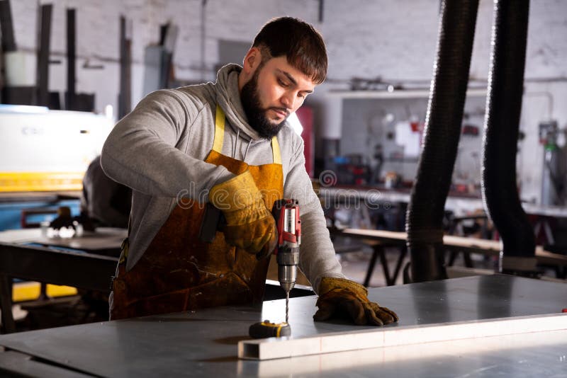 Confident Man Mechanic Drilling Metal Sheet in Workshop Stock Photo ...