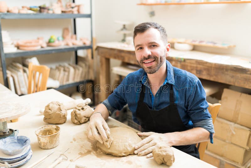 Confident Man Shaping Clay with Sponge in Pottery Class Stock Photo ...