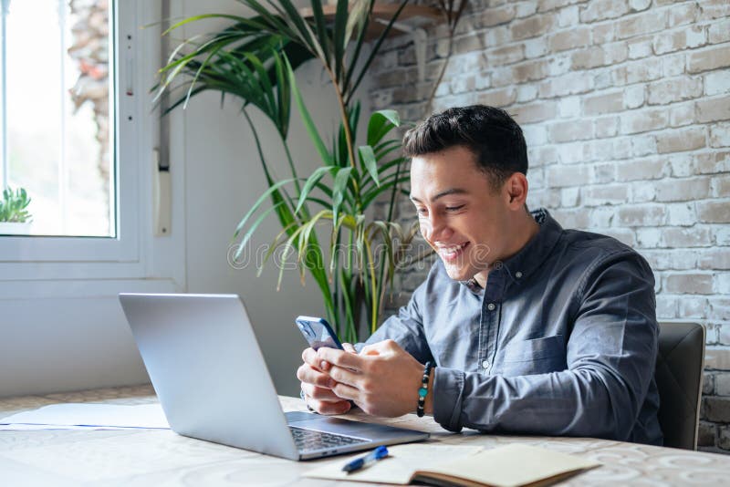 Confident Man Sitting at Desk Taking Break in Work with Electronic ...