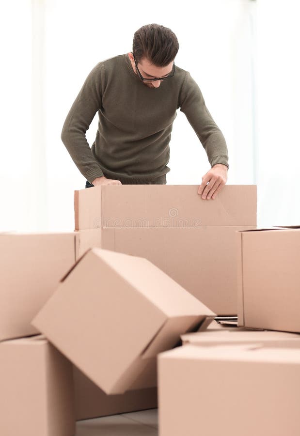 Confident Man Unpacking Boxes in the New House Stock Image - Image of ...