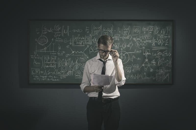 Confident Math Professor Teaching in Front of the Chalkboard Stock ...