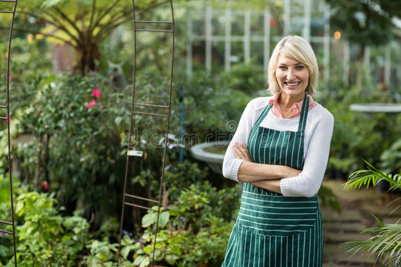 Confident Mature Gardener Standing by Plants Stock Image - Image of ...