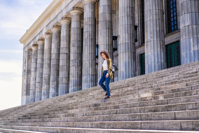 Confident Mid-adult Student Walking Down University Steps Stock Photo ...