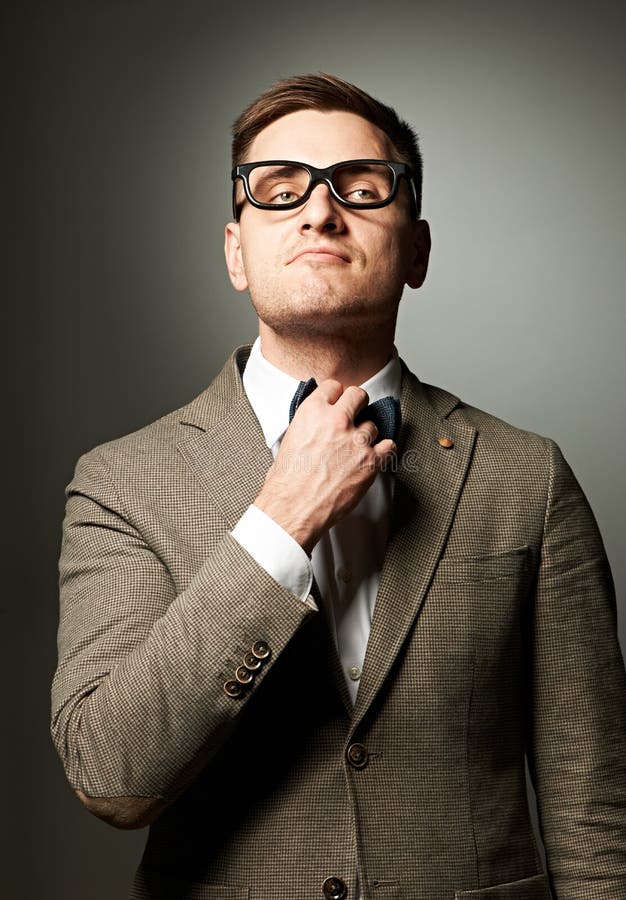 Geek Adjusting Bow Tie stock image. Image of glasses - 36292291