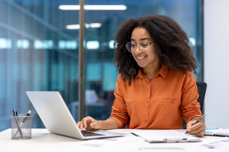 Confident Office Worker in Modern Workspace Using Laptop and Taking ...