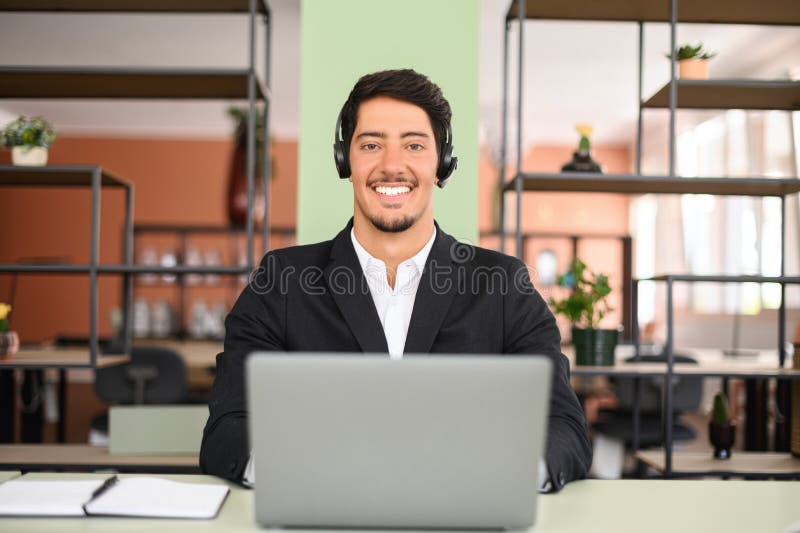 Confident Operator with Headset Looking at the Camera, Sitting with ...