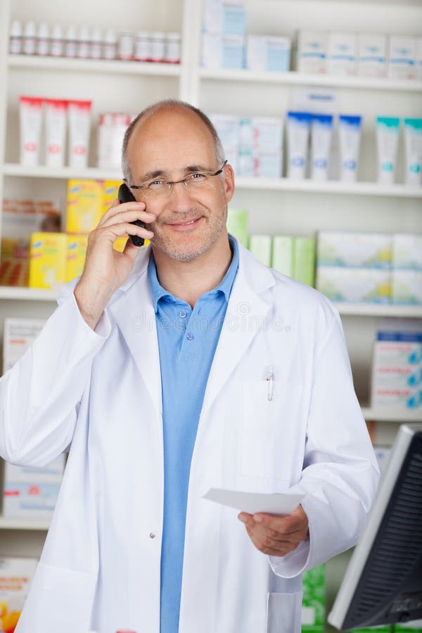 Confident Pharmacist Calling Stock Photo - Image of cordless ...