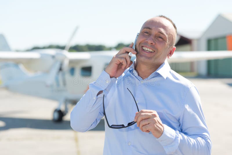 Confident pilot on phone stock photo. Image of portrait - 150567890