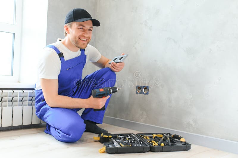 Confident Professional Electrician in Uniform Using Screwdriver while ...