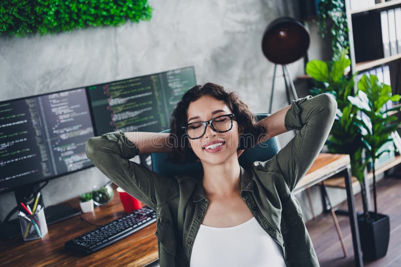 Young Female Programmer Relaxing in Modern Workspace with Multiple ...
