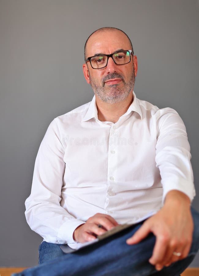 Confident Professional Sitting with Documents in a Comfortable Modern ...