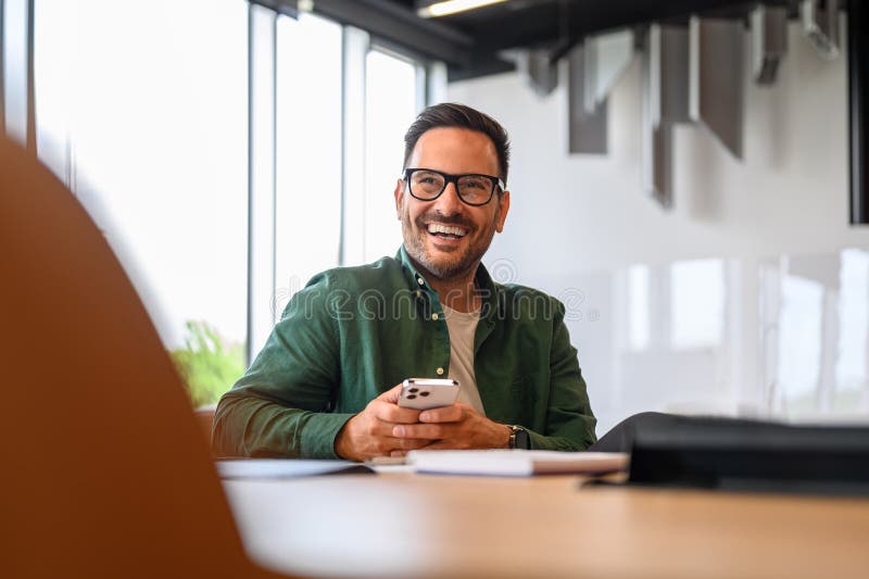 Confident Project Manager in Glasses Using Smartphone and Looking Away ...