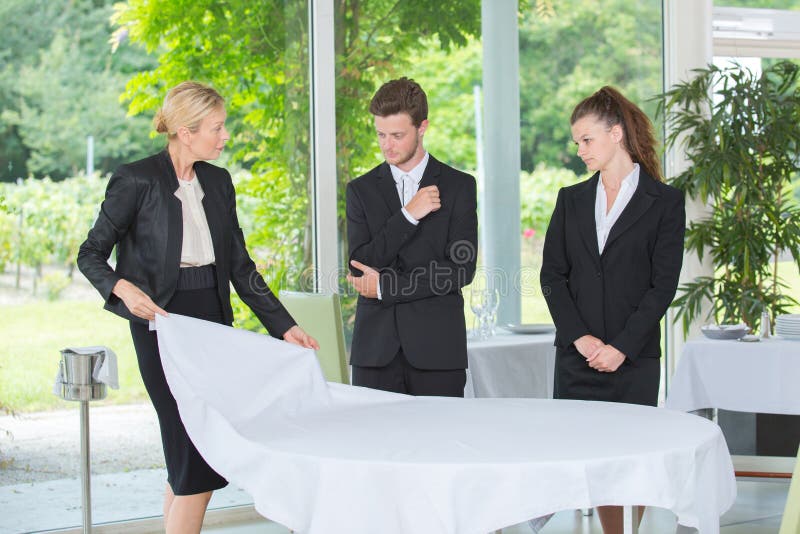Confident Restaurant Staff Setting Tables in Gourmet Restaurant Stock ...