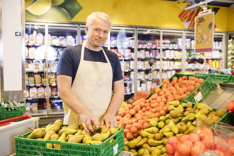 Confident Salesman Arranging Fresh Pears in Supermarket Stock Image ...