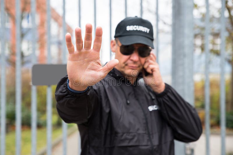 Confident Security Guard Using Mobile Phone Outside Building Stock ...