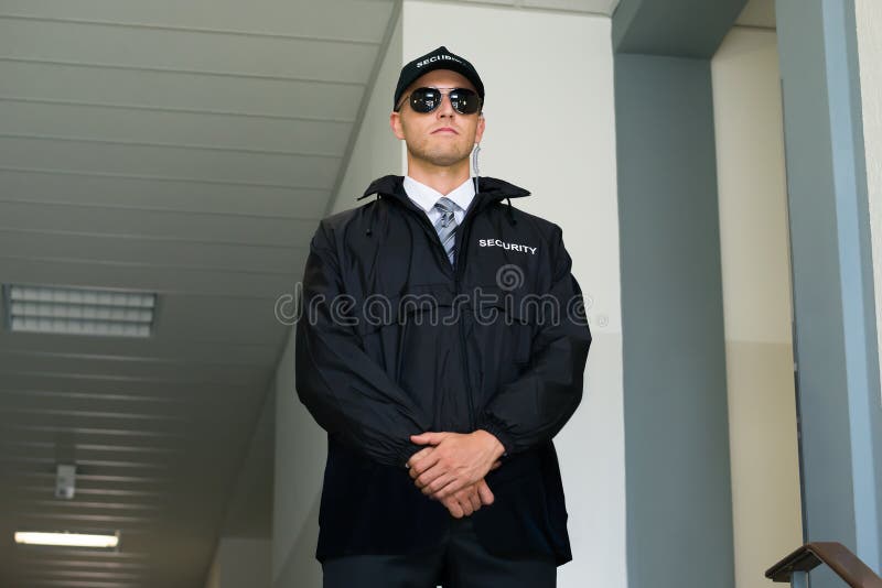 Confident Security Guard Using Mobile Phone Outside Building Stock ...