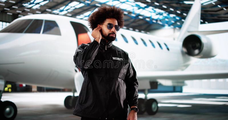 Confident Security Guard Walks by Private Jet Stock Photo - Image of ...