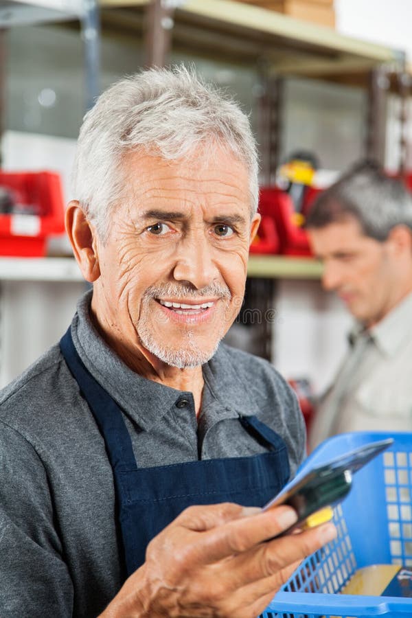 Confident Senior Salesman Holding Tool in Store Stock Image - Image of ...