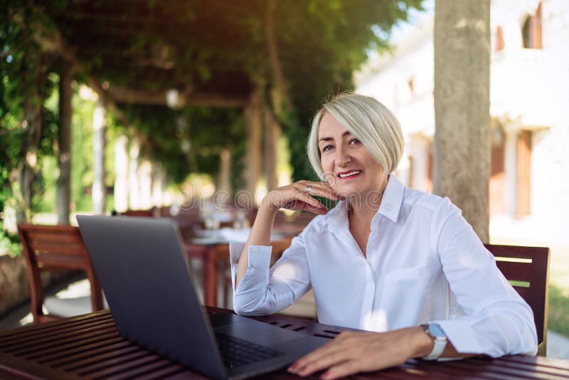 Senior Woman Sitting at a Cafe with Laptop Computer Stock Image - Image ...