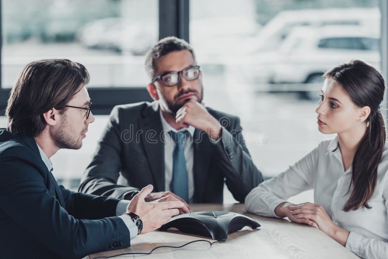 Confident Serious Business People Using Conference Phone Stock Photo ...