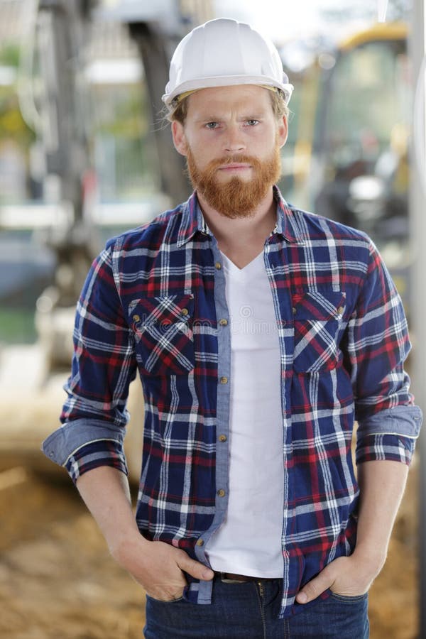 Confident Serious Construction Worker Standing with Hands in Pockets ...