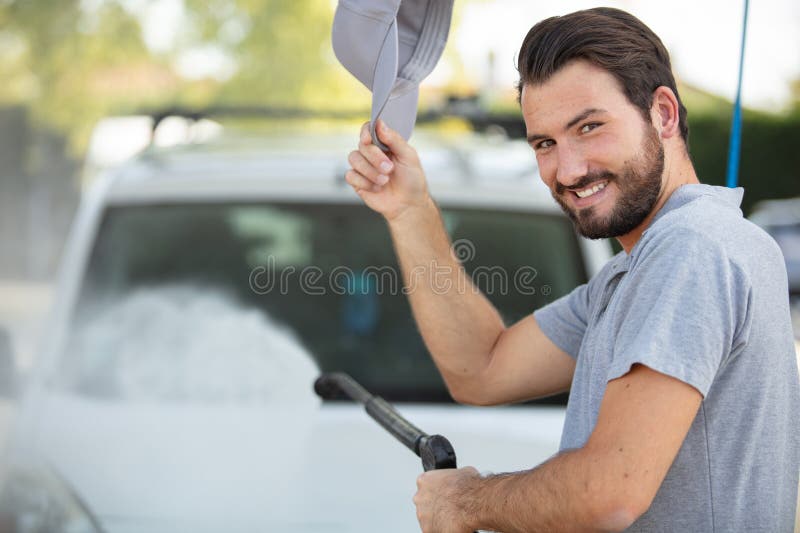 Confident Serviceman with High Pressure Water Jet Washing Car Stock ...