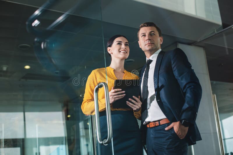 Confident Smiling Co-workers Standing Behind Transparent Wall Stock ...