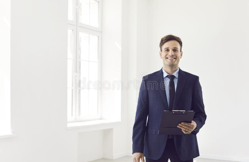 Man Realtor Agent Standing in Empty Apartments with Documents in Hands ...