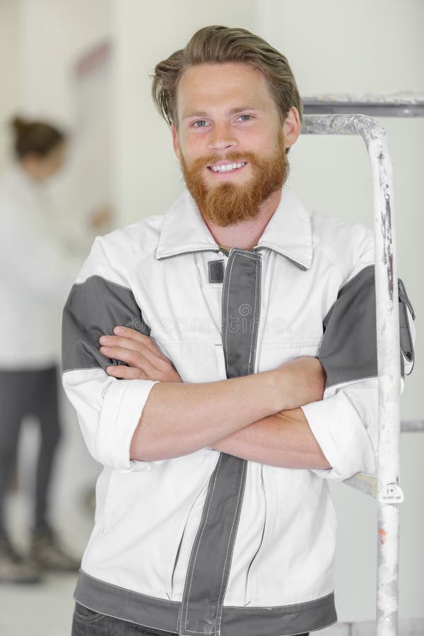 Confident Smiling Painter with White Overalls Posing with Arms Crossed ...