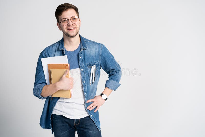 Confident Student. Studio Portrait of Handsome Young Man Holding Books ...