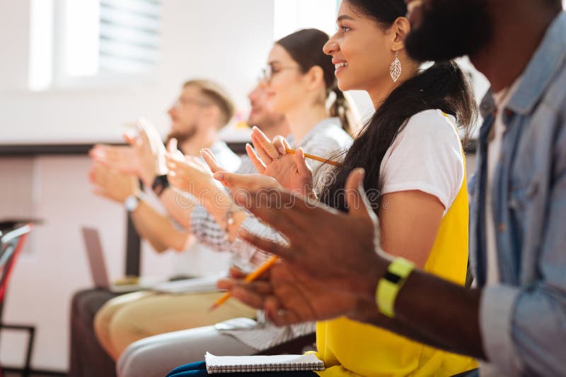 Confident Students Sitting in a Row and Smiling while Applauding Stock ...